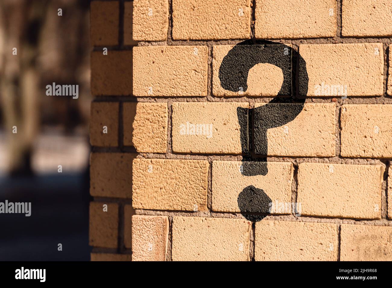 Question mark concept or FAQ. The sign is painted on a brick wall Stock ...