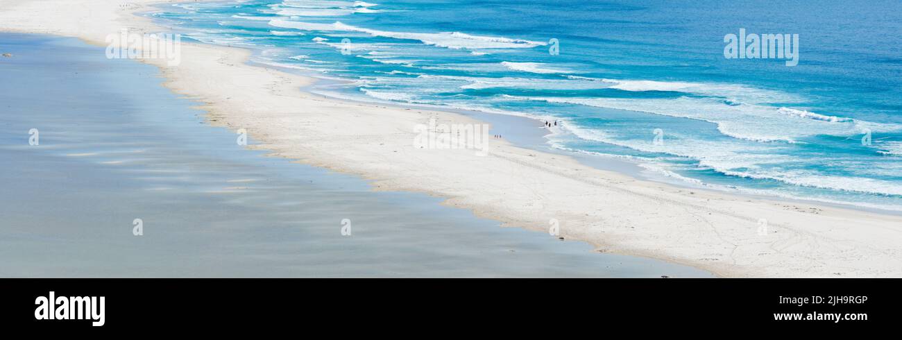 Copy space at the sea with calm ocean waves washing onto a beach shore ...