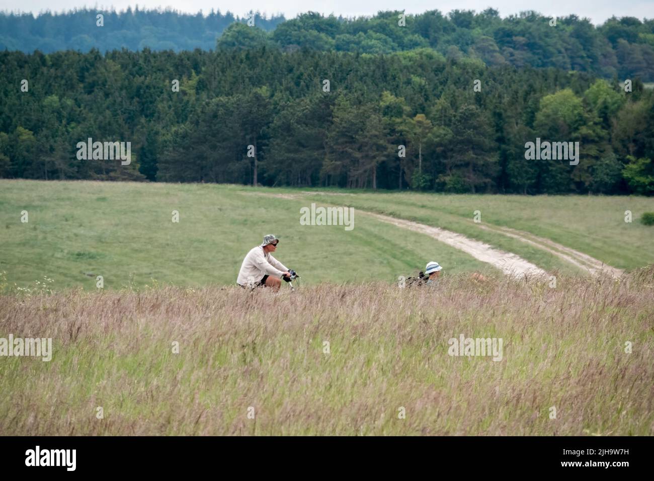 a casual cyclist accompanies a recumbent cyclist across a country cycle ...
