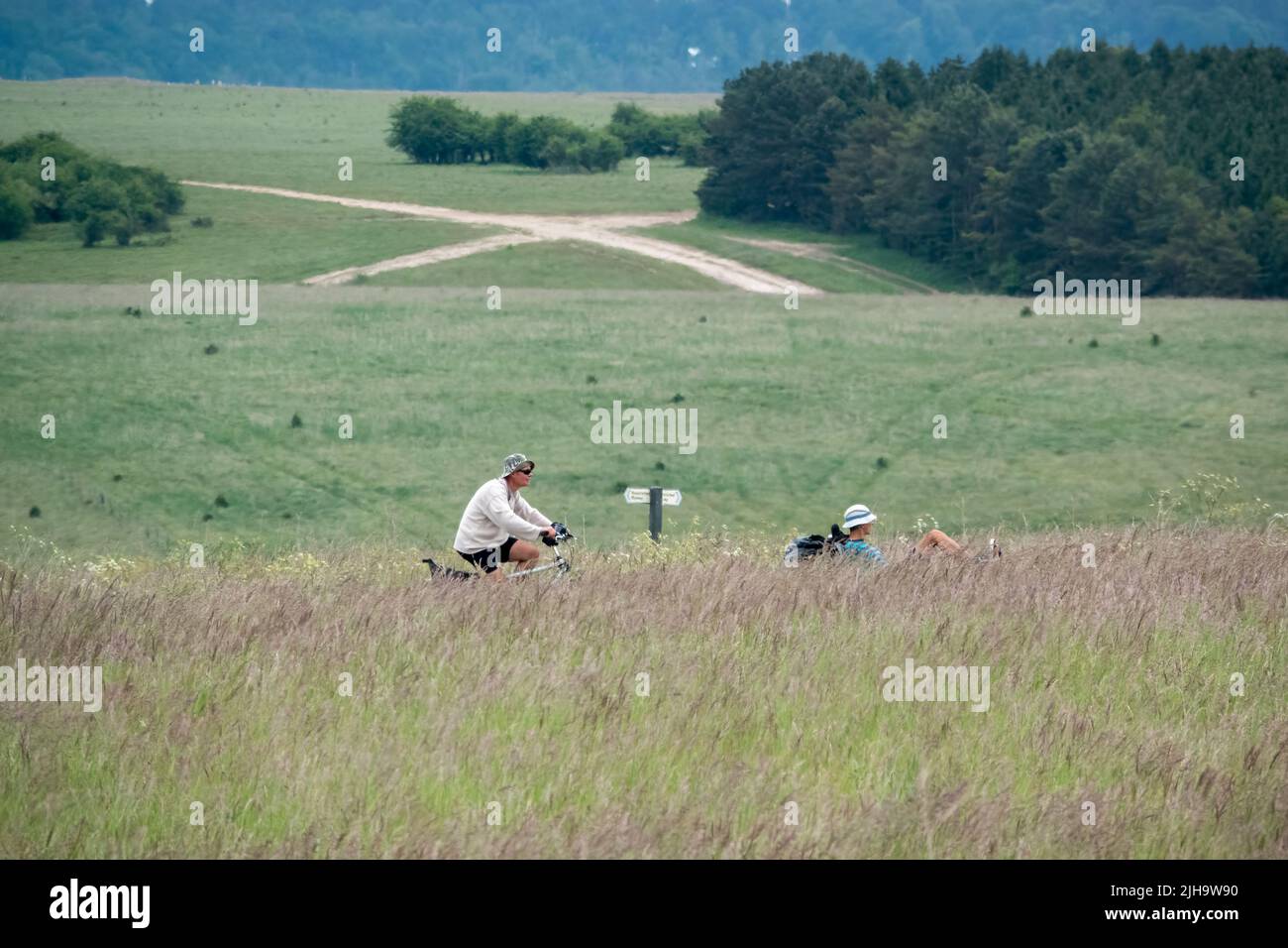 a casual cyclist accompanies a recumbent cyclist across a country cycle ...
