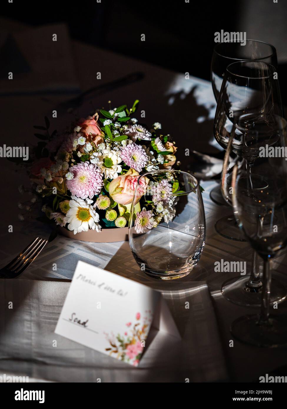 Wedding table decorations. Flowers, figurines of the bride and groom ...