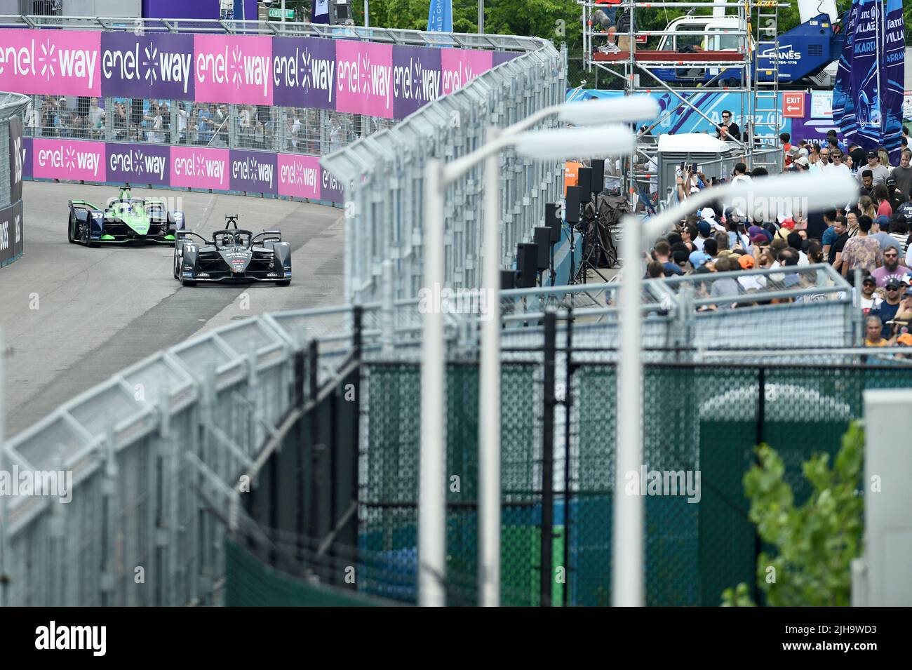 View of two Formula E race cars (l) on the tracks and the fence work ...