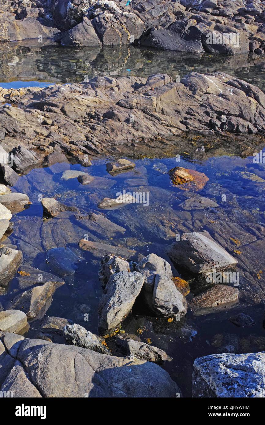 Ocean tide forming natural rock dipping pools for swimming and relaxing ...