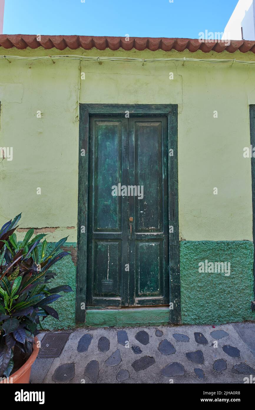 Old abandoned house or home with a weathered green wall and broken ...