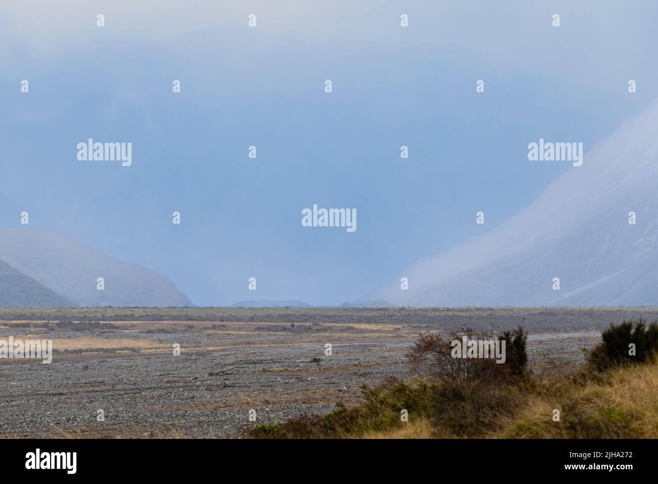 Diminishing perspective of mountain ridges fading into mist around flat ...