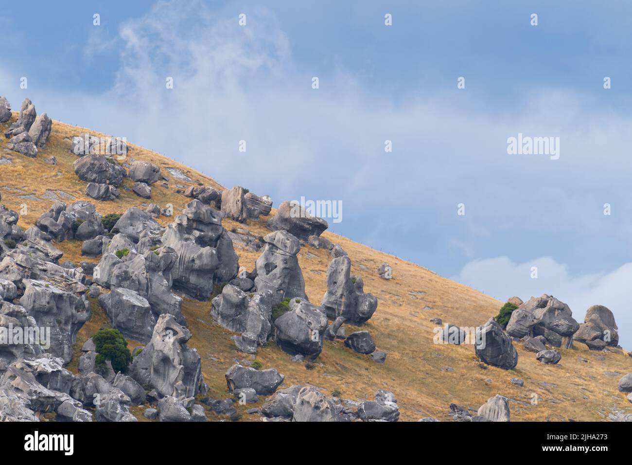 Rocky sloping landscape scattered rocks on dry brown grassy slope Stock ...