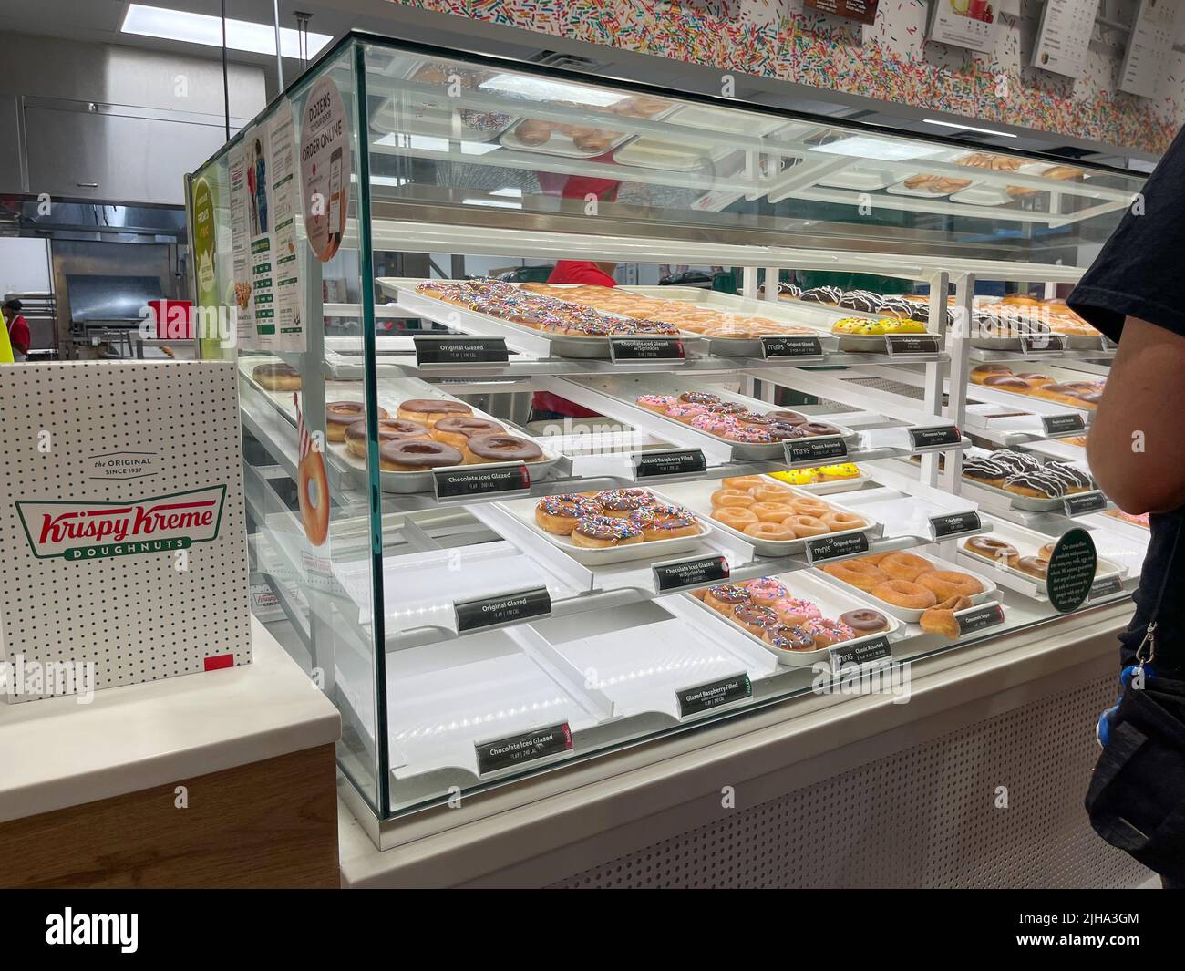 Inside of a Krispy Kreme doughnut shop. People in line to buy donuts ...
