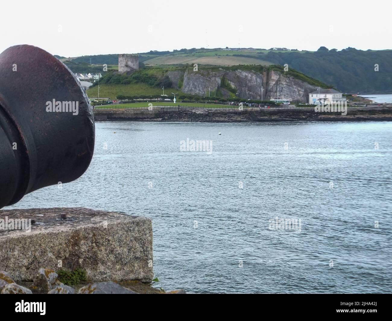 An antique cannon is aimed across the Cattewater toward Mount Batten in ...
