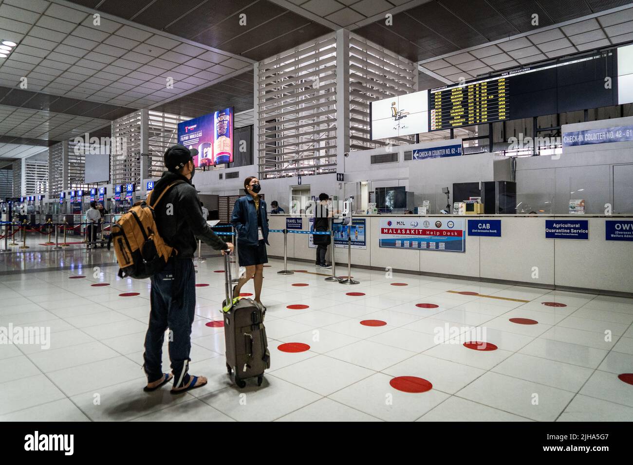 Manila, Philippines. 17 July 2022. A traveler looks for departure times ...