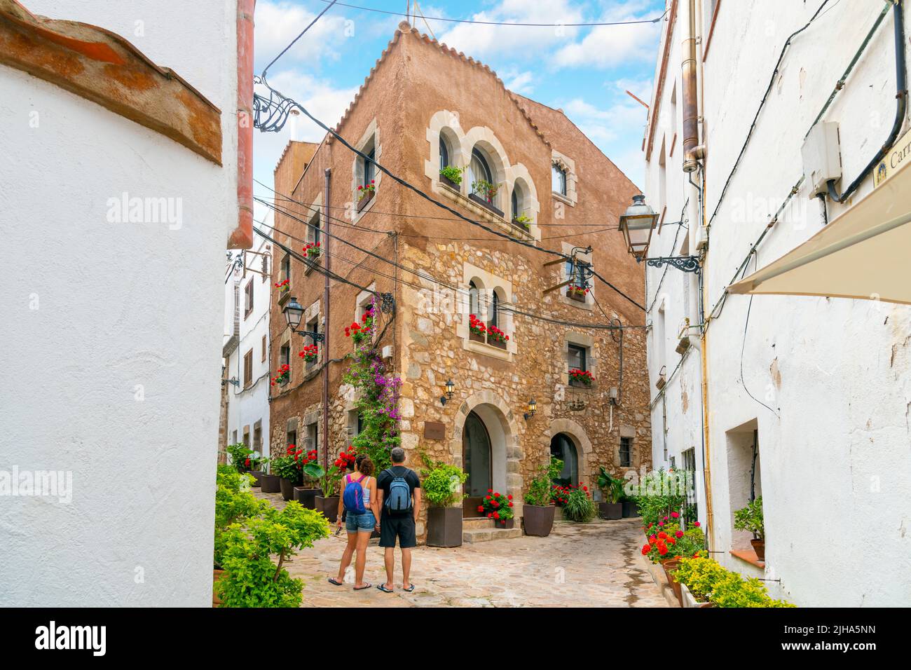 A backpacking couple decide which alley to walk in the medieval ...
