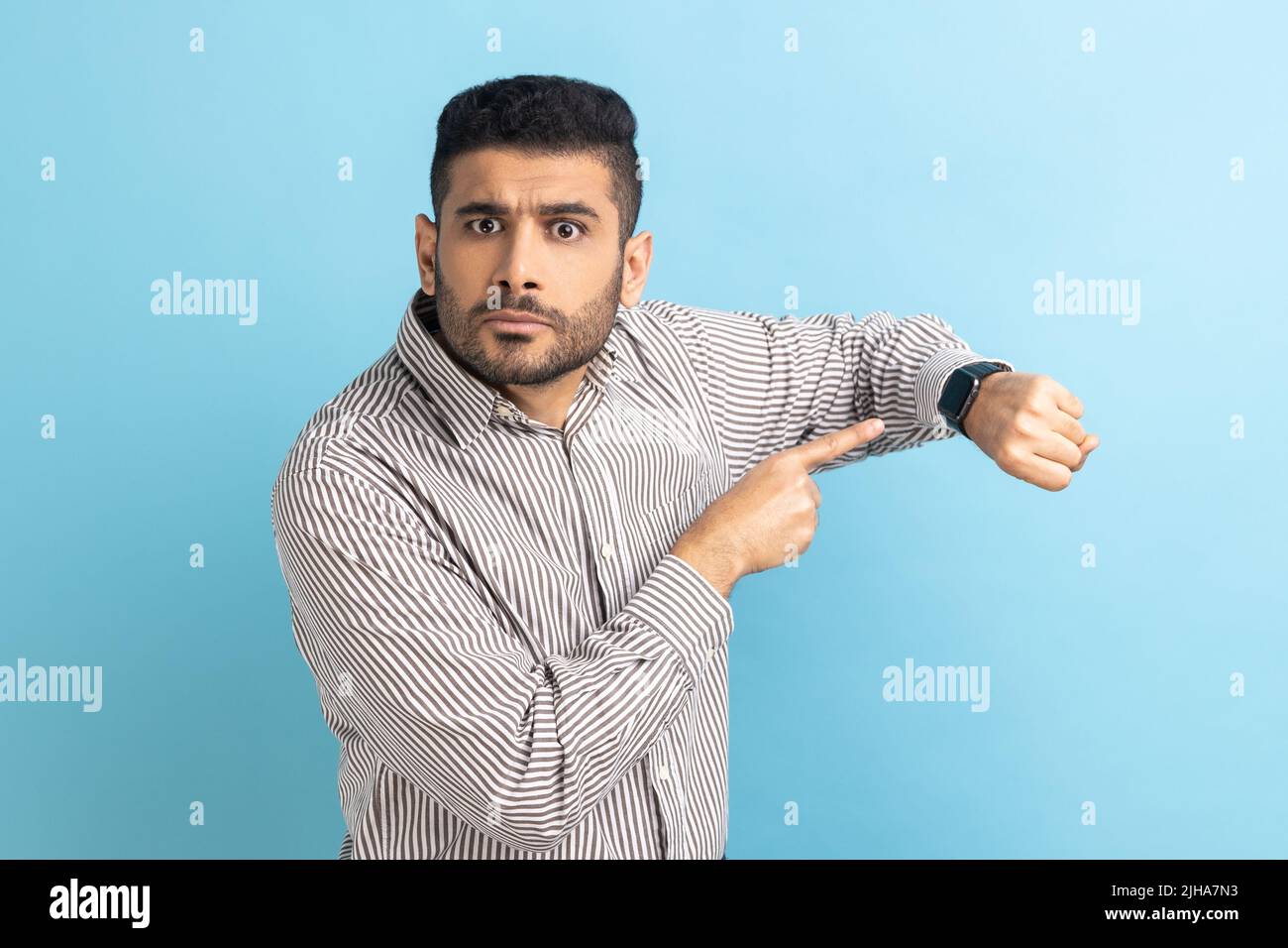 Look at time. Impatient bossy businessman with beard pointing finger at ...