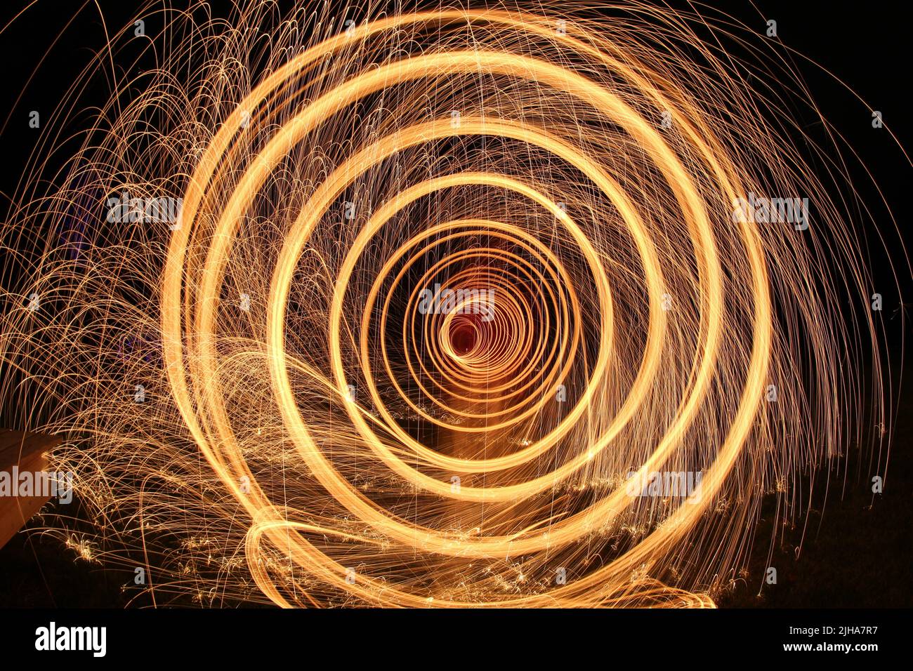 A steel wool spiral tunnel sparkling at night Stock Photo - Alamy