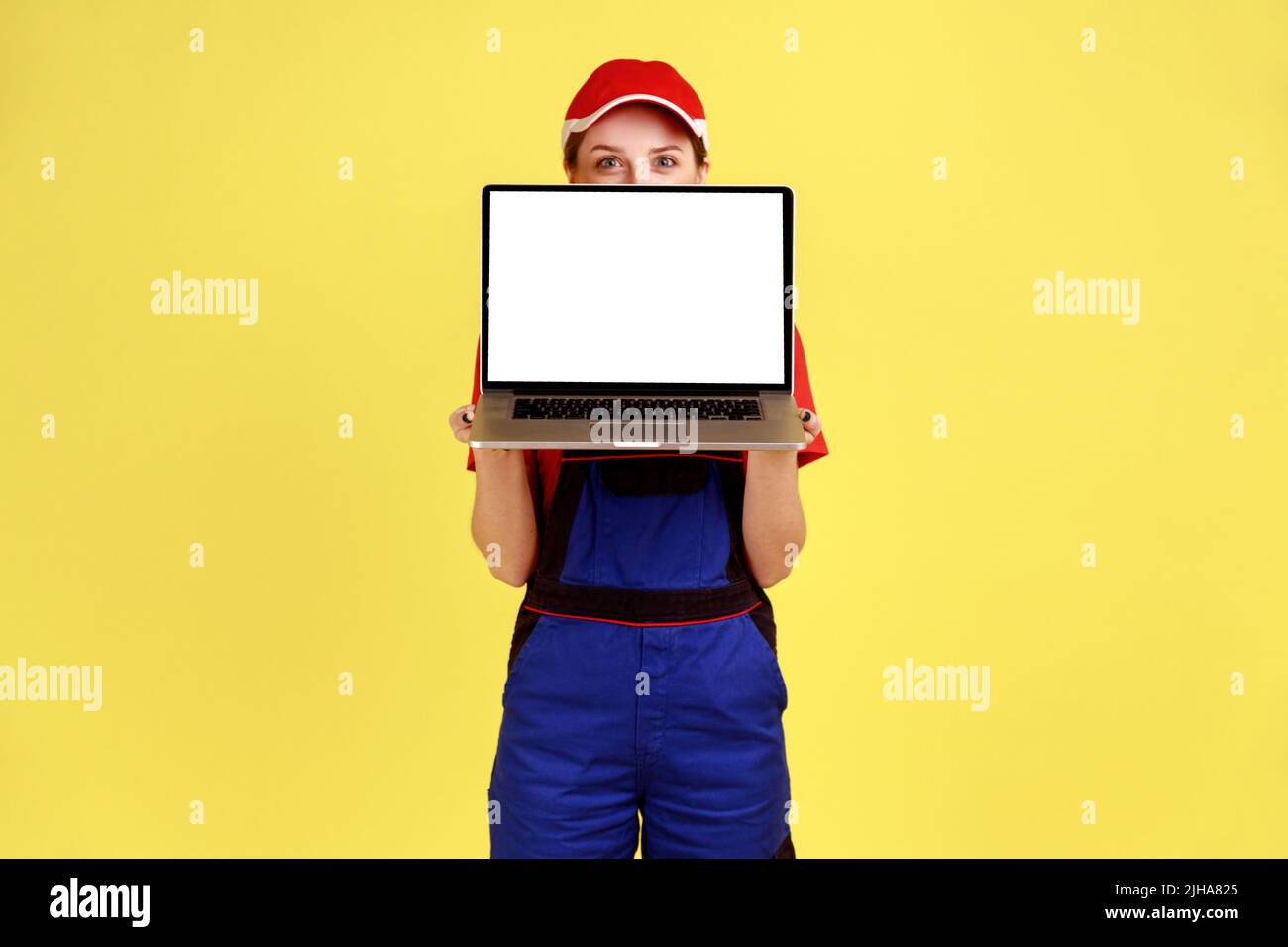 Full length portrait of unknown worker woman standing covering half of ...