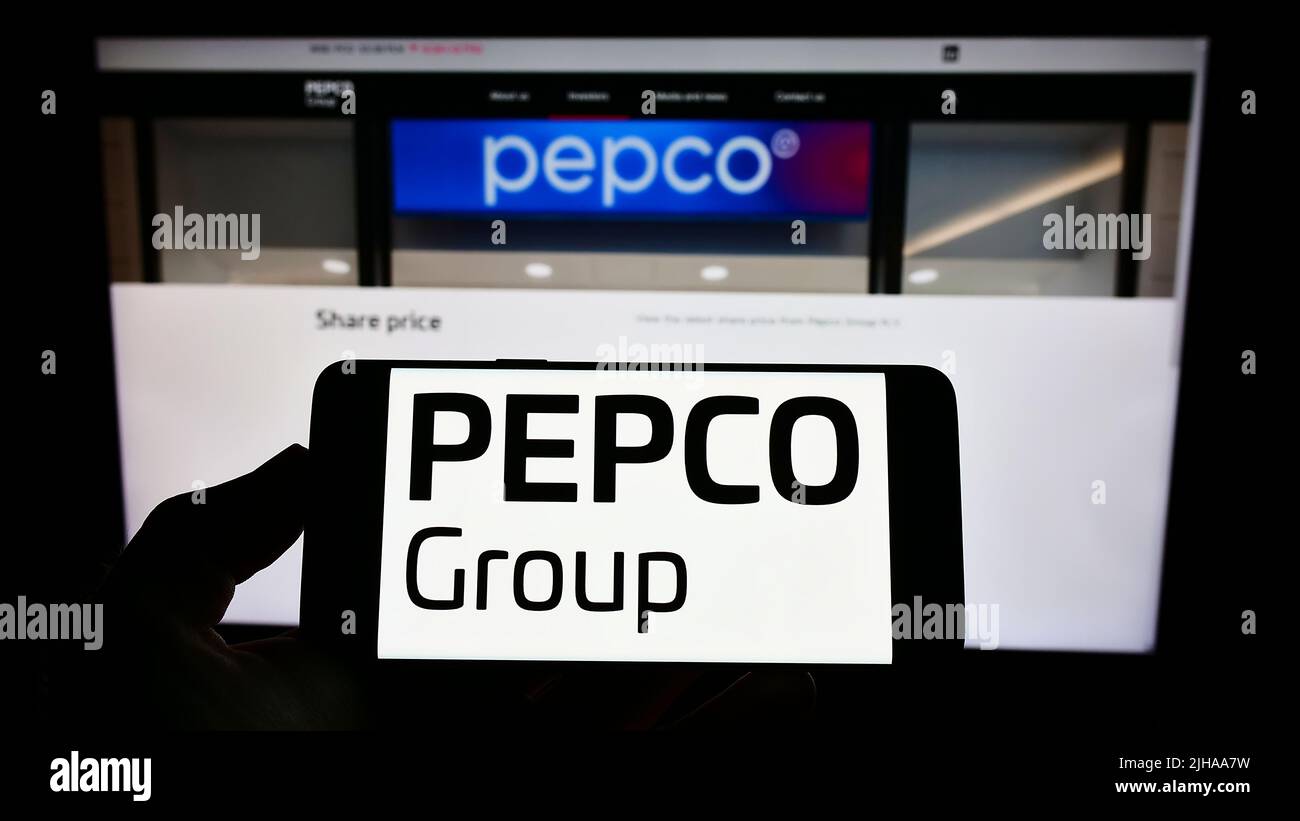 Person holding mobile phone with logo of retail company Pepco Group N.V ...
