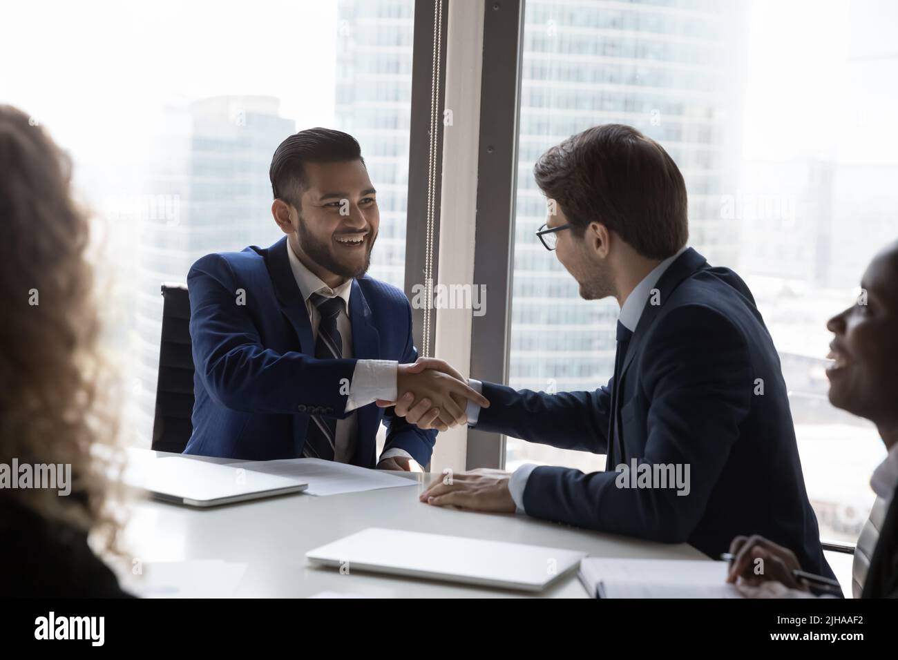 Company leader, boss congratulating happy successful employee on career ...