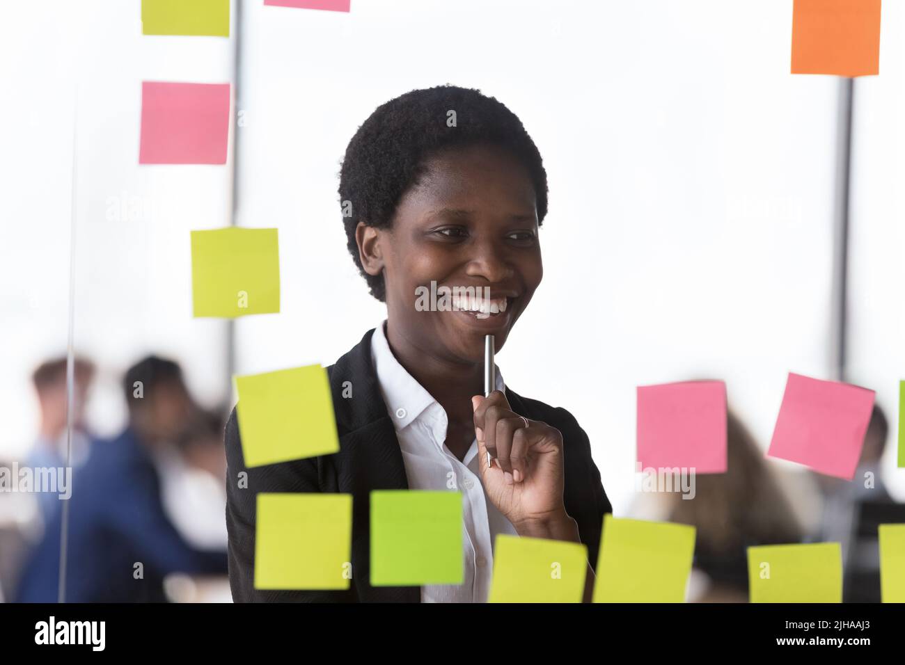 Happy successful African American business woman thinking over project ...