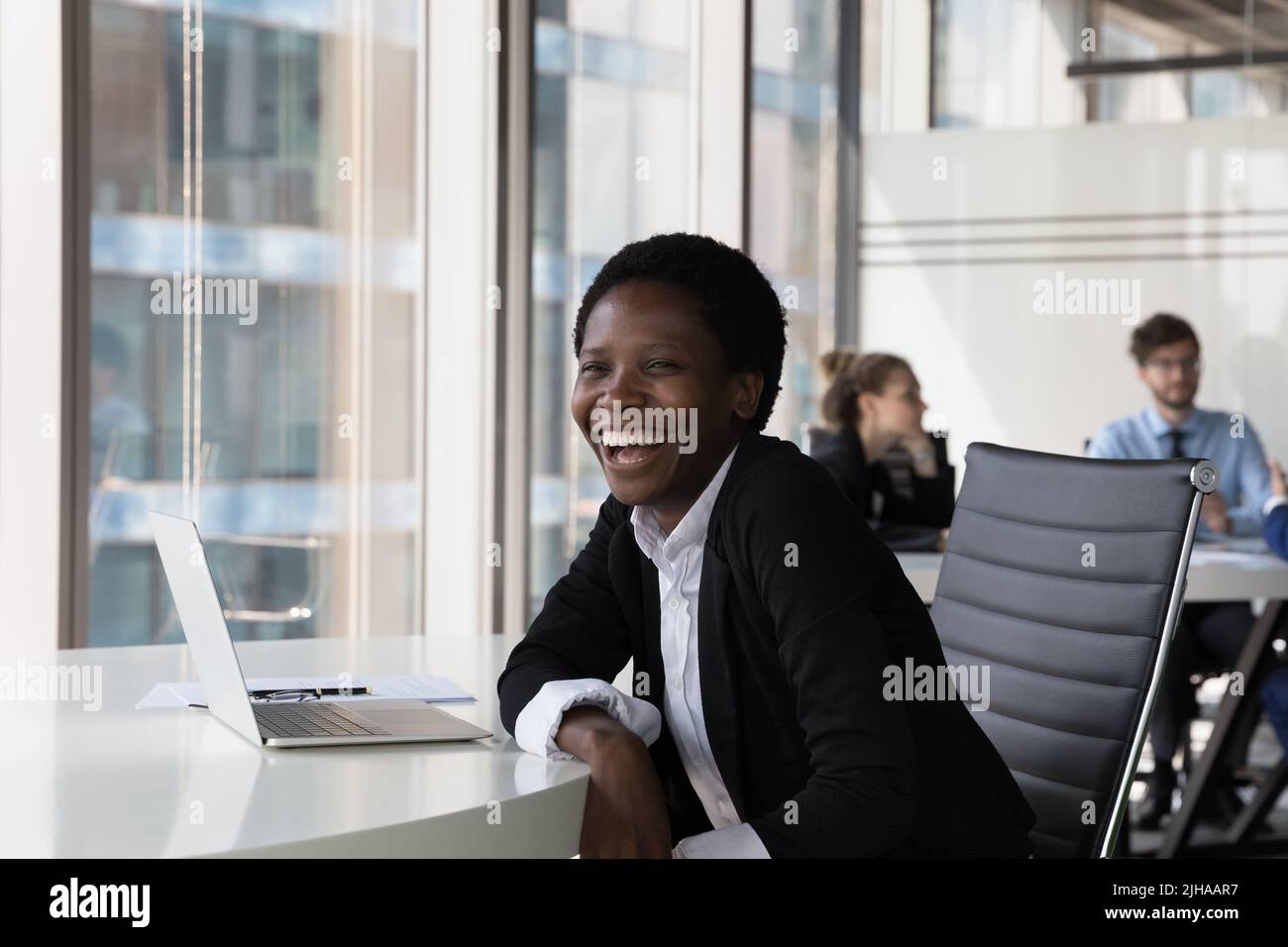 Happy excited African employee woman laughing at computer Stock Photo ...