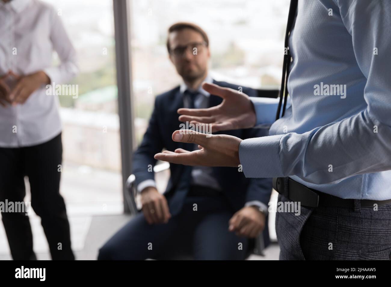 Hand gesture of male business leader talking to employees Stock Photo ...