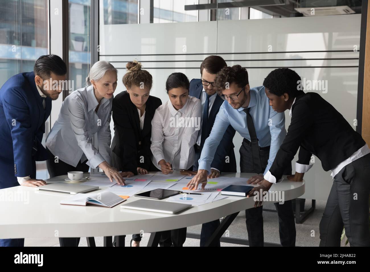Diverse different aged business group standing at meeting table Stock ...