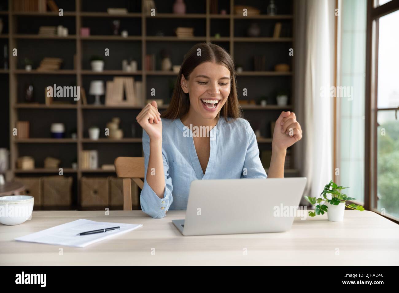 Happy female office employee read pleasant e-mail on laptop Stock Photo ...