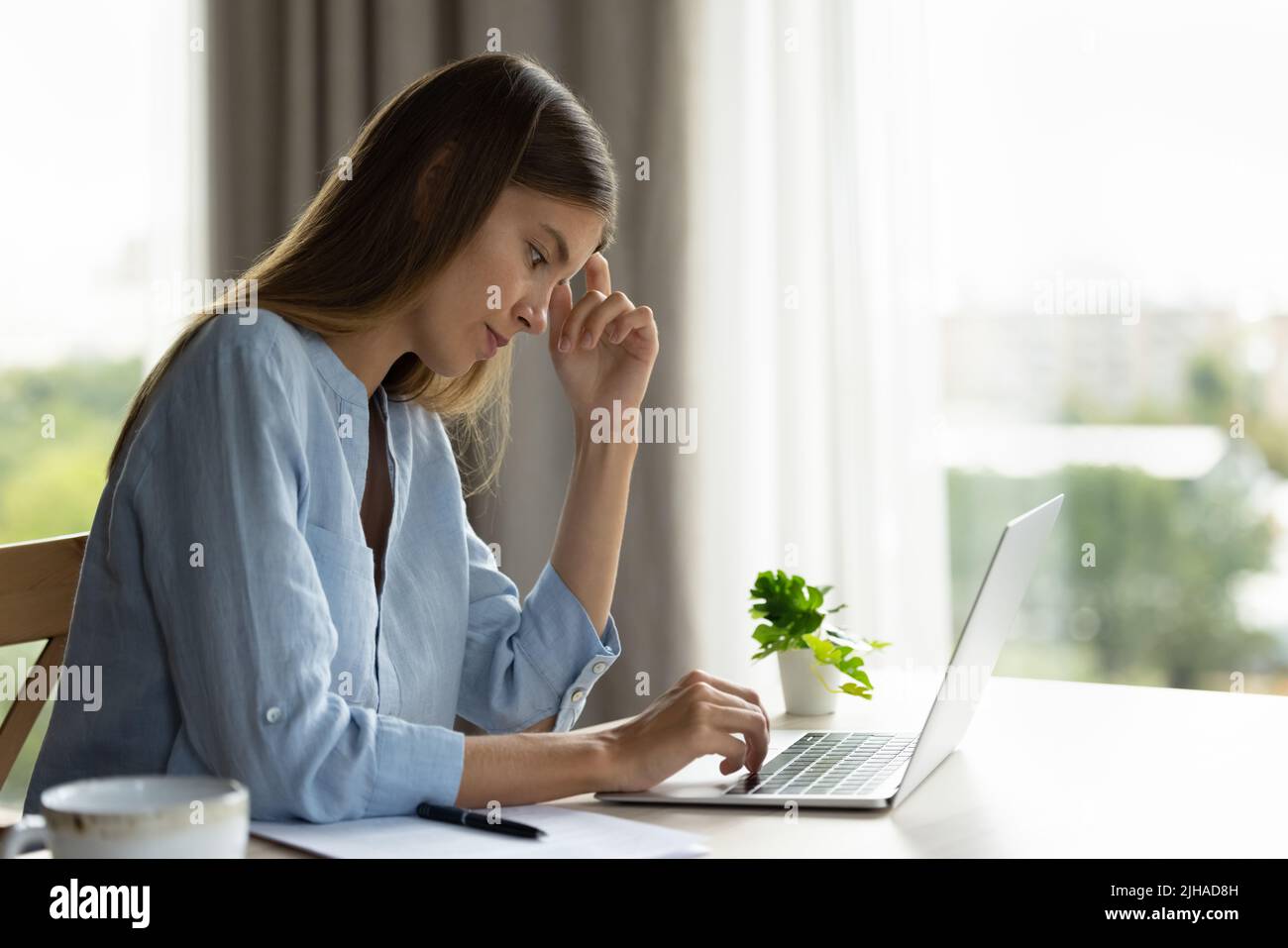 Woman sit at desk with laptop read email feels frustrated Stock Photo ...