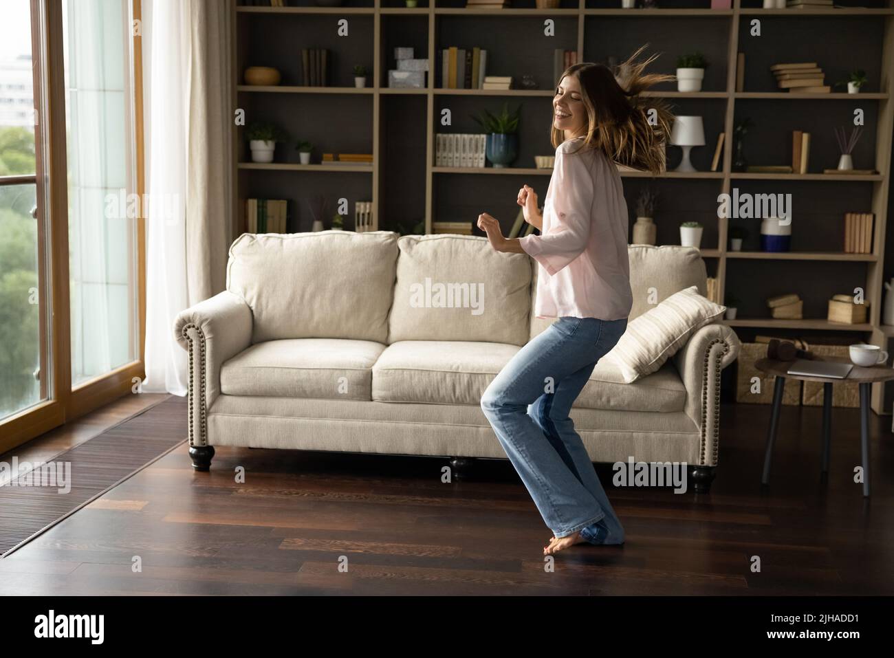 Lively woman dancing in modern living room at home Stock Photo - Alamy