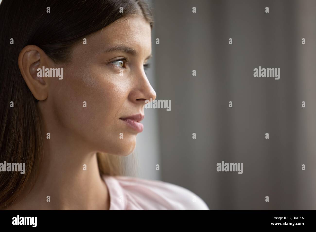 Profile view face serious beautiful young woman Stock Photo - Alamy