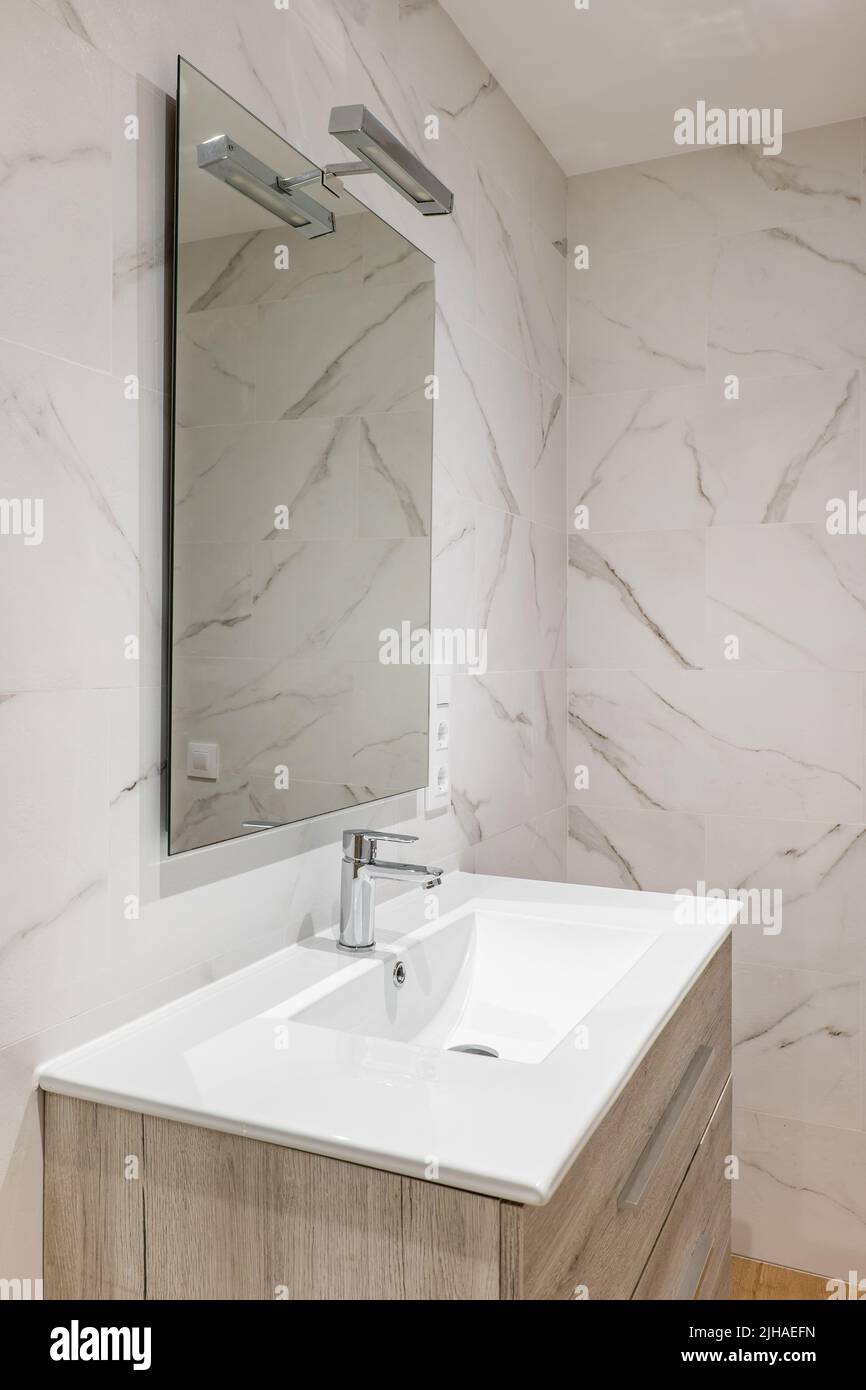 Simple and modern bathroom with marble tiles, sink and mirror Stock ...