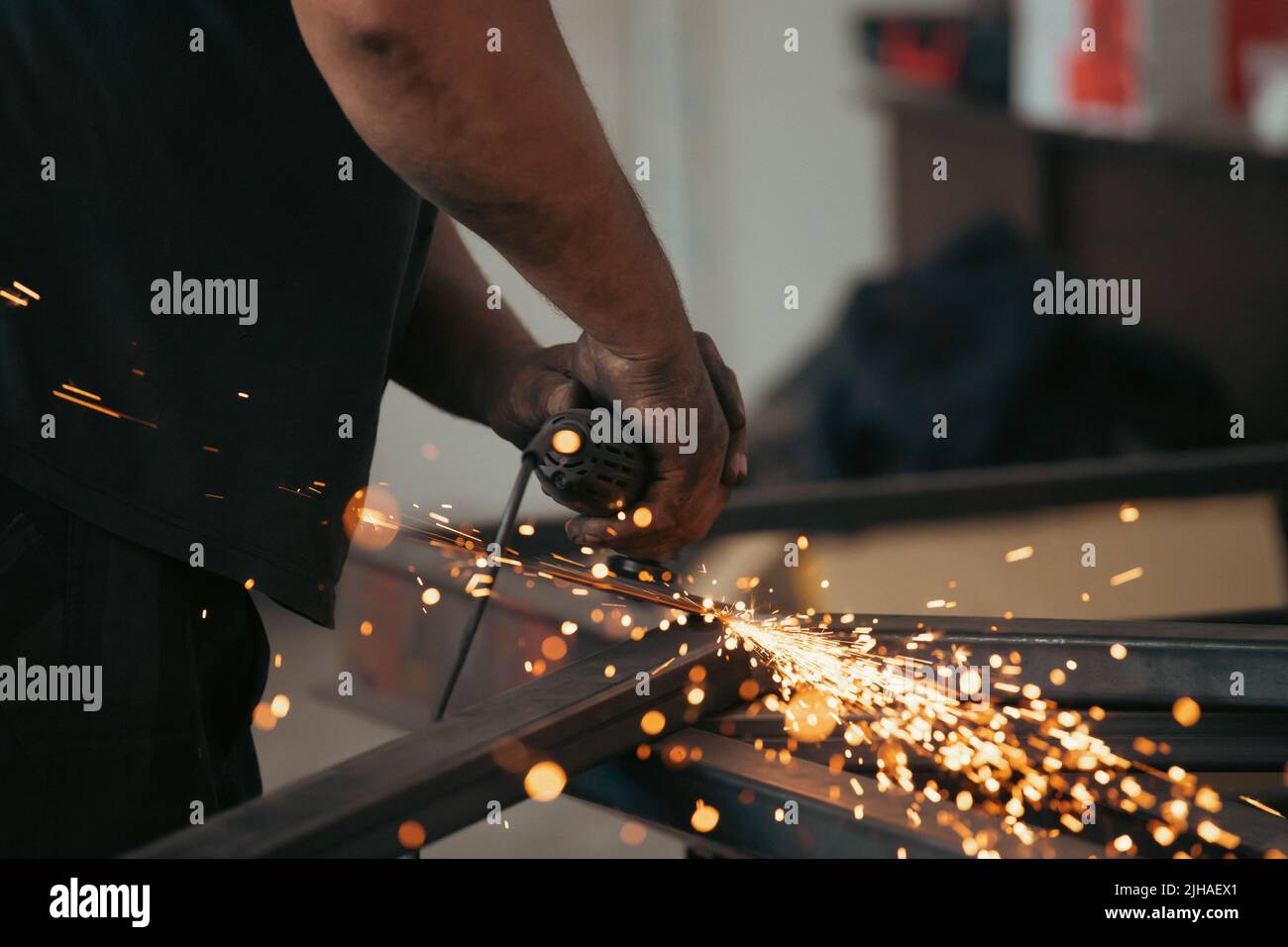 Profesional fabric worker cutting metal profile on the work table with ...
