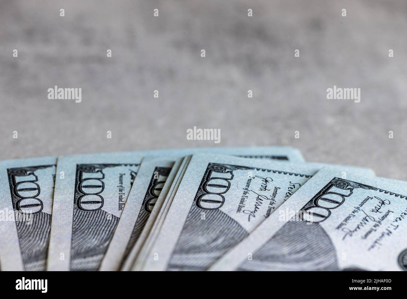 American money, 100 dollar bills, on gray background, place for text ...