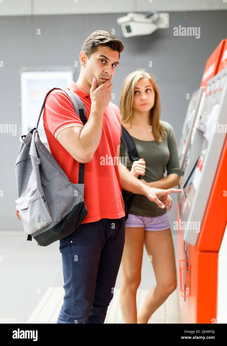 Couple is buying tickets and moving around the city Stock Photo - Alamy