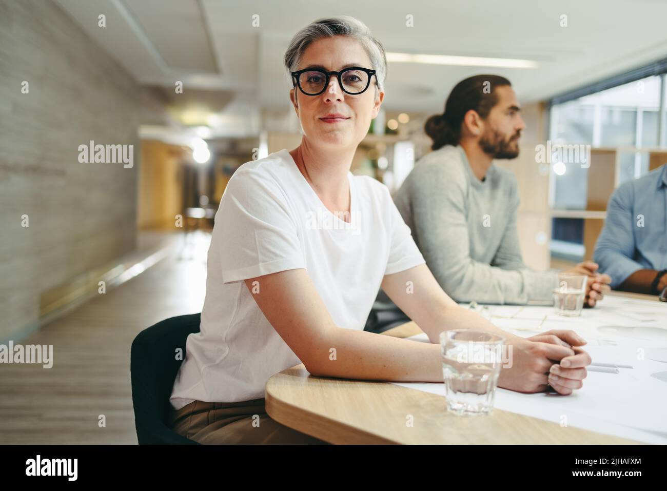 Mature design professional looking at the camera while sitting in a ...