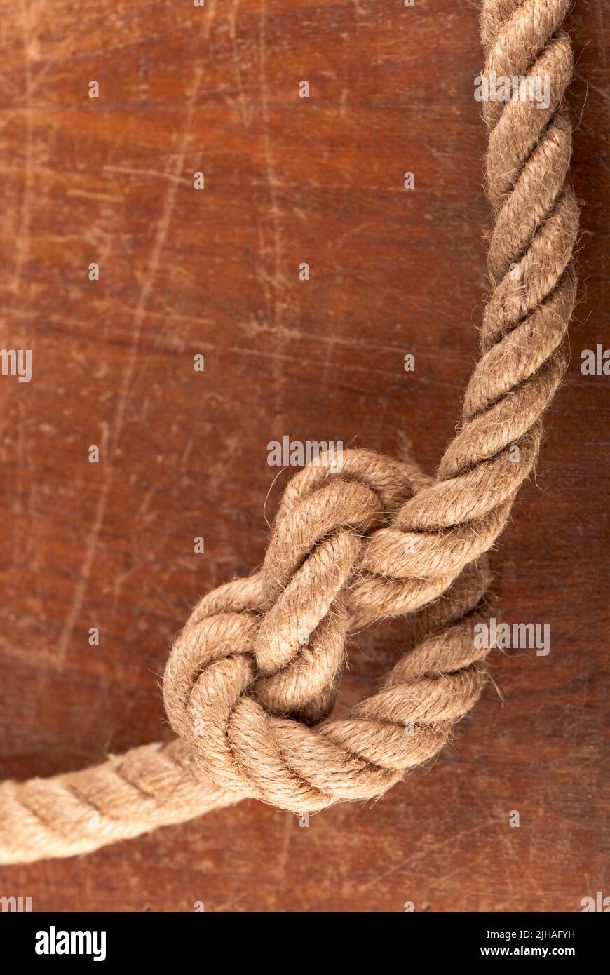 Rope with Reef Knot on Wood Texture Stock Photo - Alamy