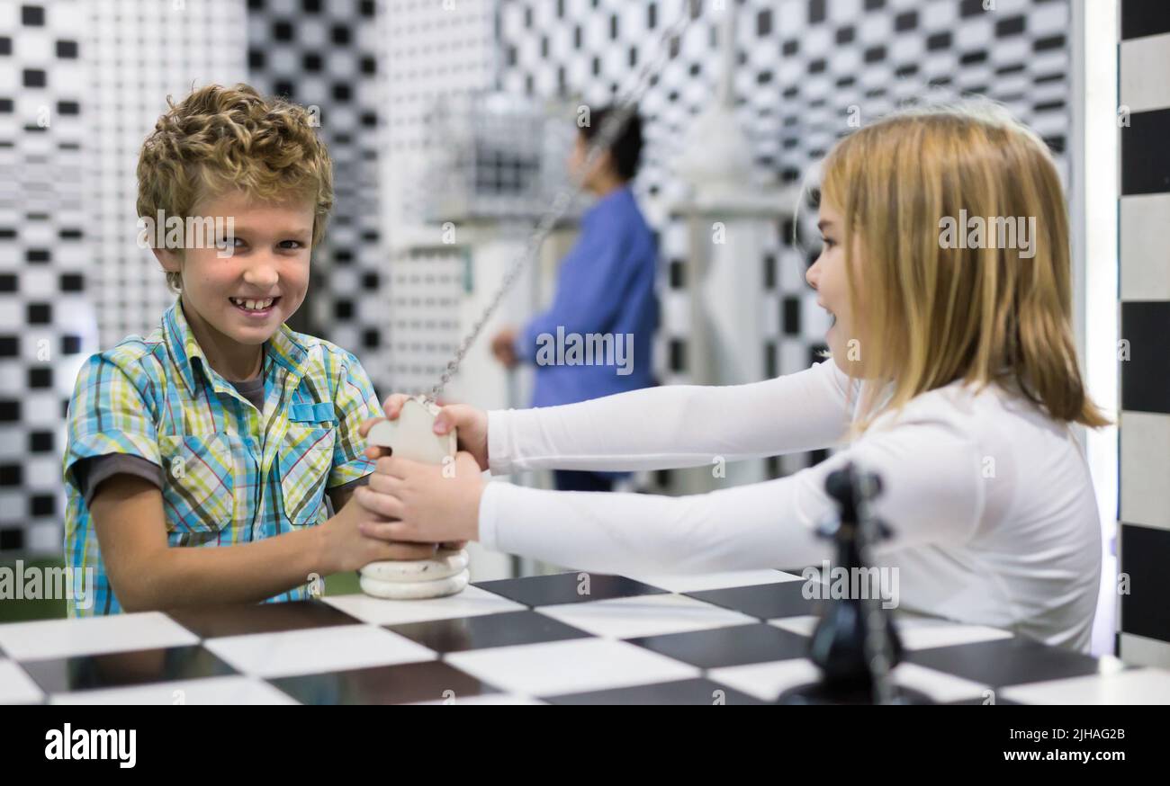 Tweens trying to get out of escape room stylized under chessboard Stock ...