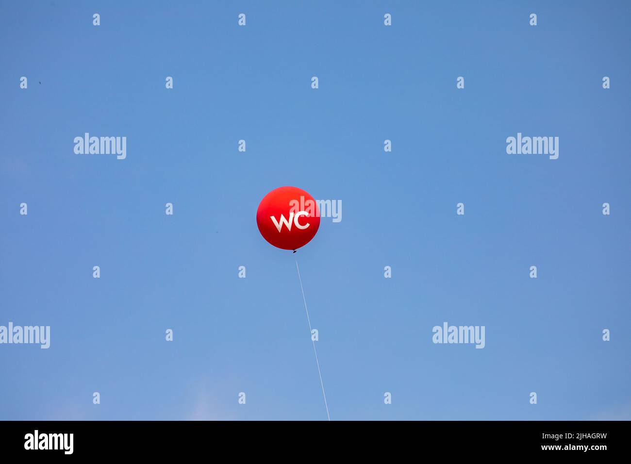 A giant red balloon in the air indicating the toilet location during ...