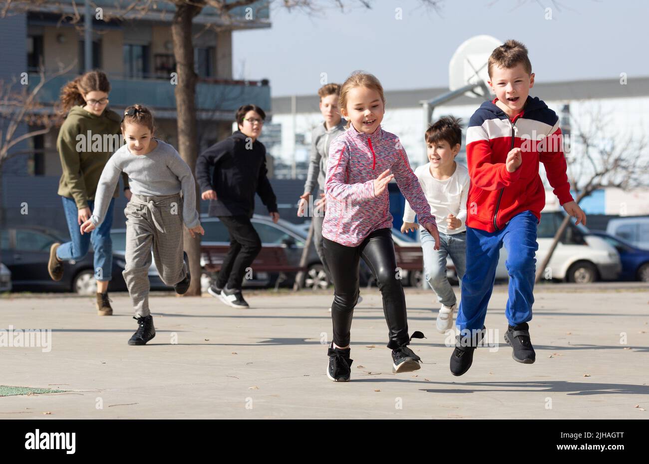 Group of joyful children running down the city street Stock Photo - Alamy