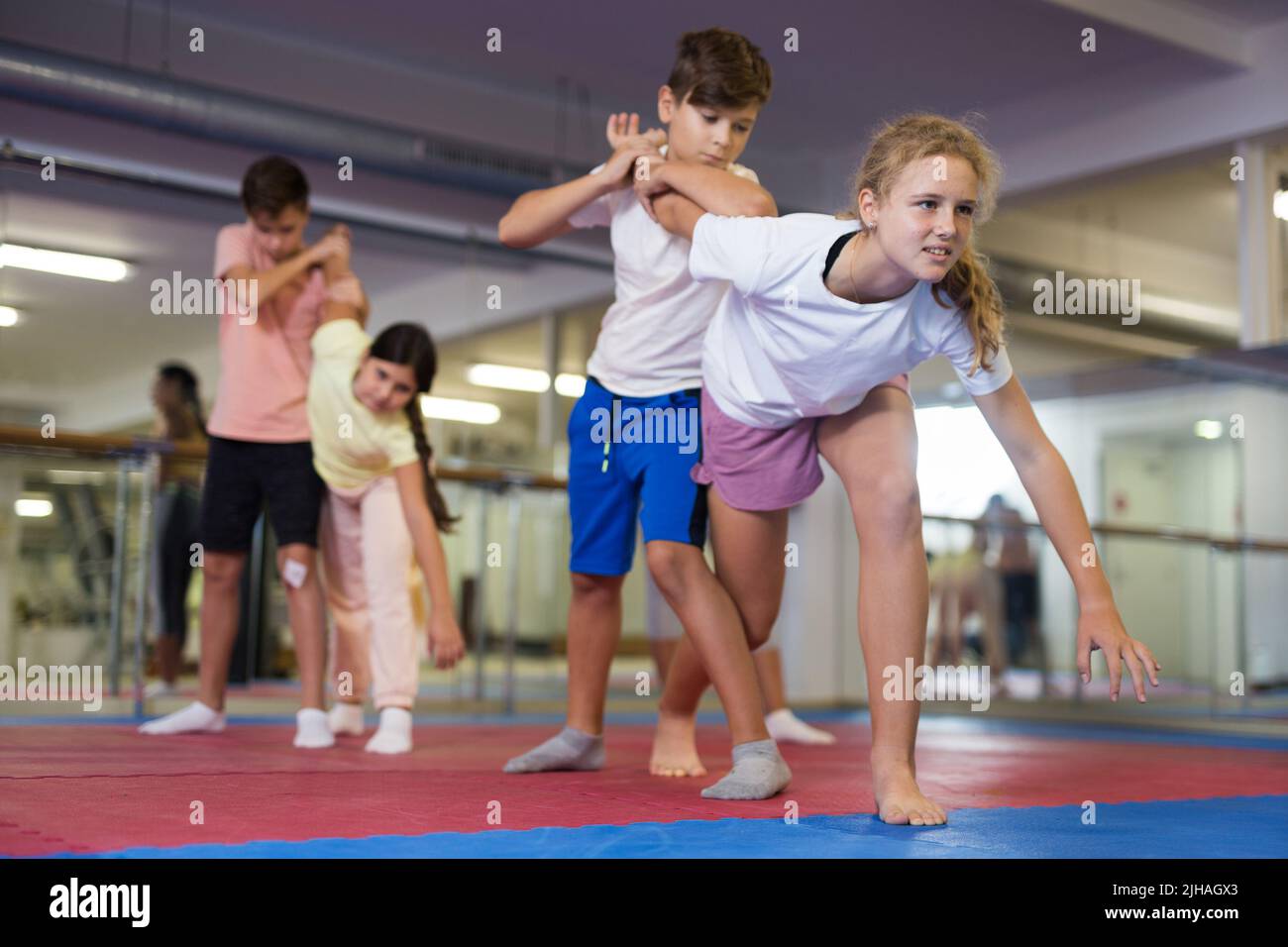 Kids learning self-defence moves in gym Stock Photo - Alamy