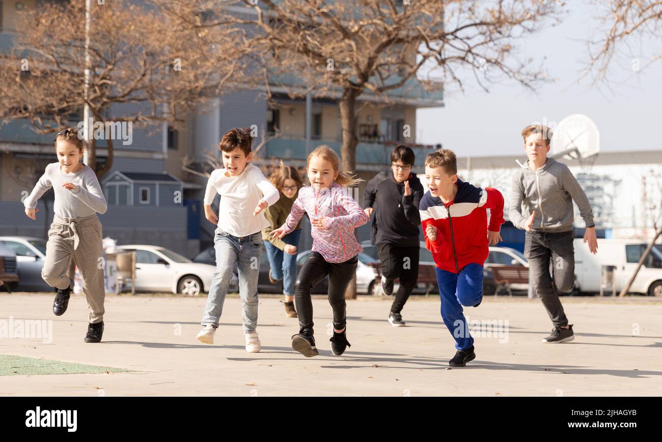 Happy children running on city street Stock Photo - Alamy