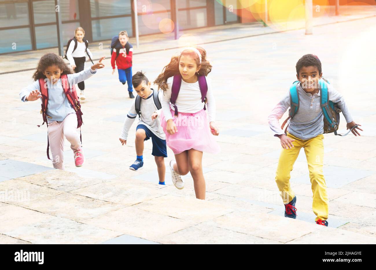 Happy schoolchildren running in the race from school outdoors Stock ...
