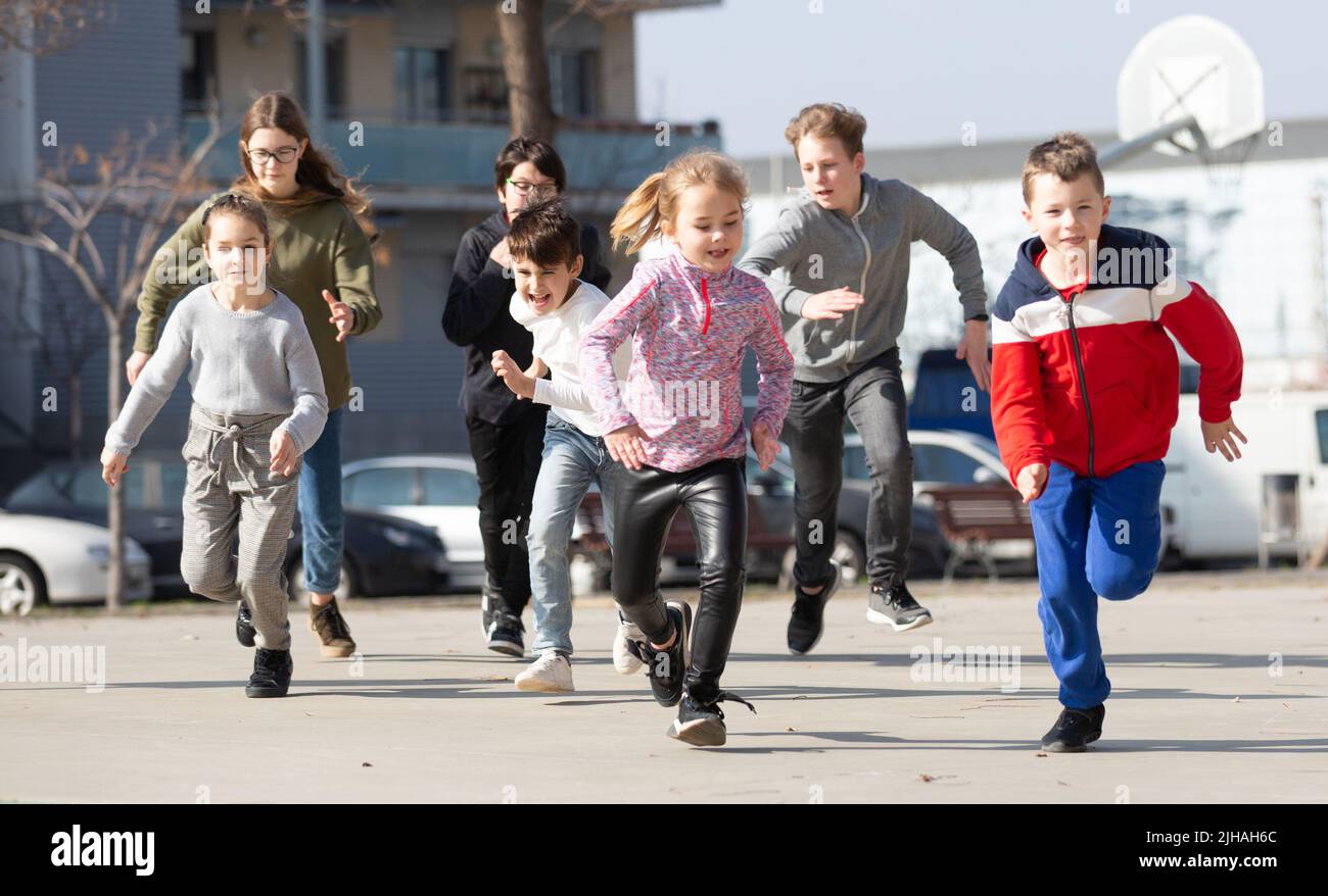 Happy children running on city street Stock Photo - Alamy