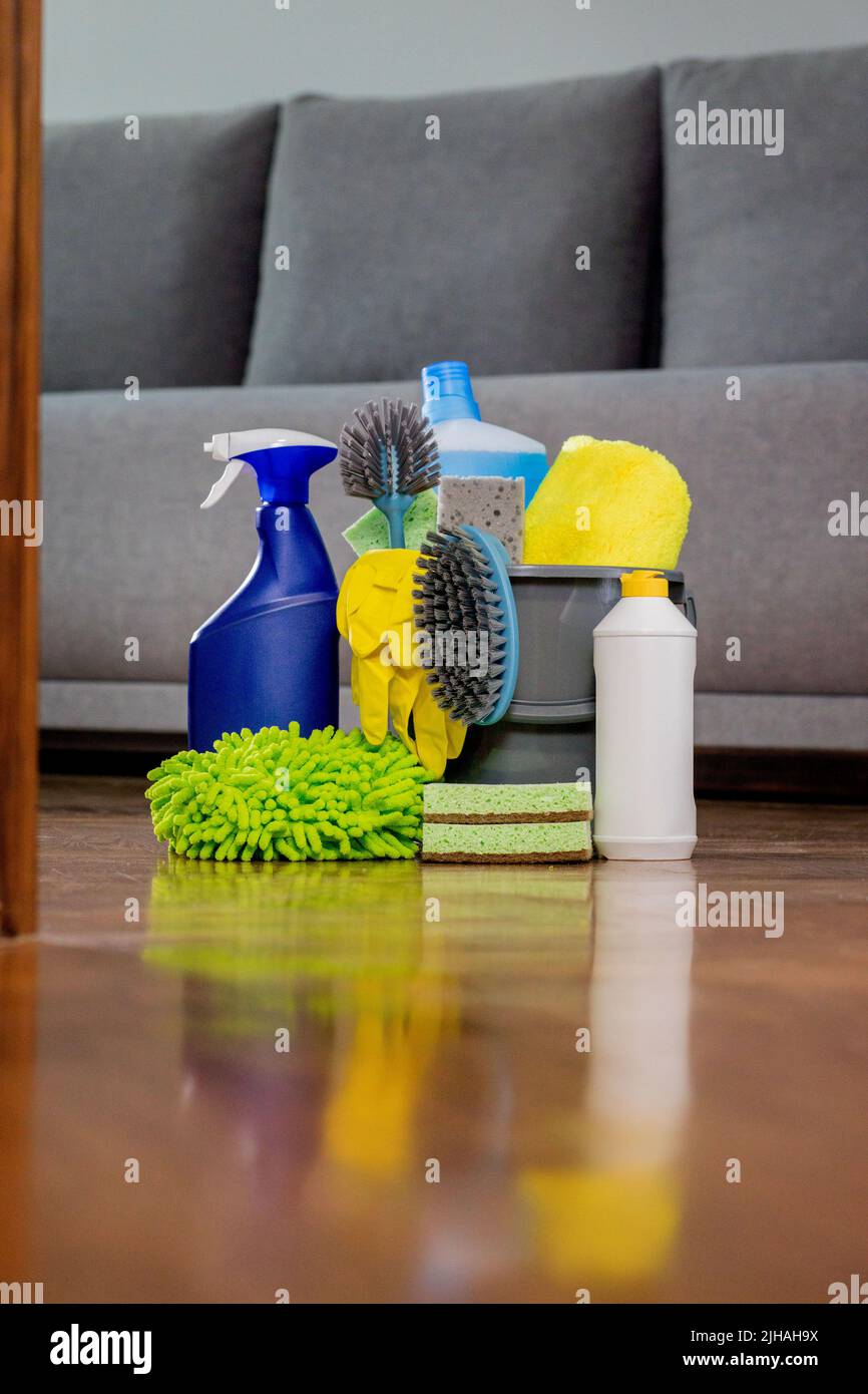 Household cleaning products and rags with reflection in the floor ...