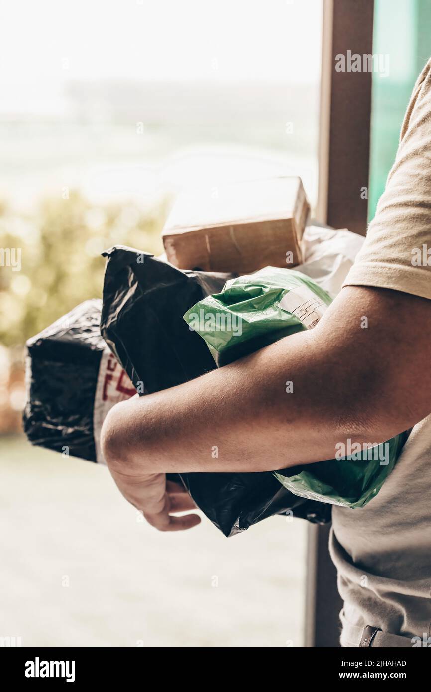 A young man holding delivery parcels Stock Photo - Alamy
