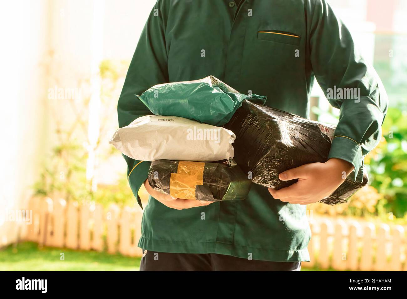 A young man holding delivery parcels Stock Photo - Alamy