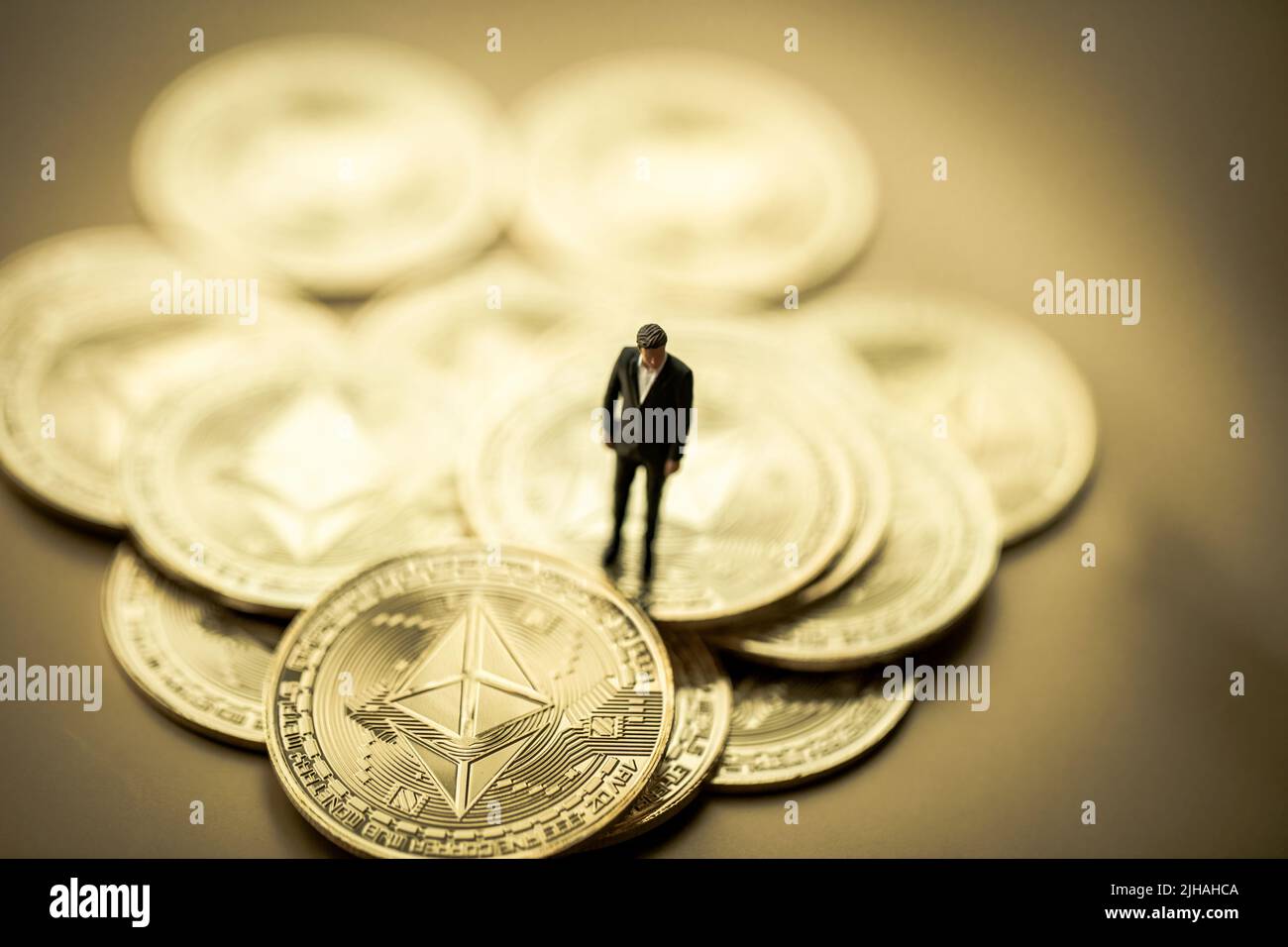Stack of golden ether coins or Ethereum coins close up on golden ...