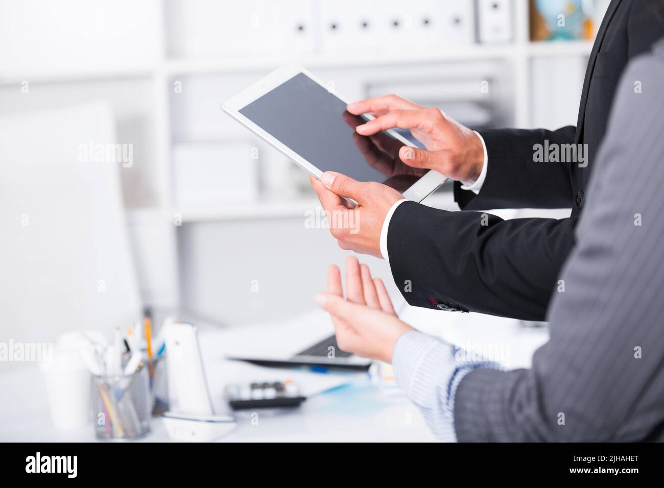 Business team using phone and tablet Stock Photo - Alamy