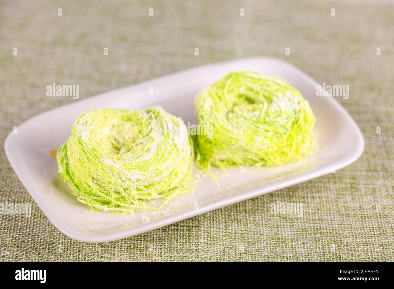 Green pulled sugar or bird nest or Dragon Beard candy. Also known as ...