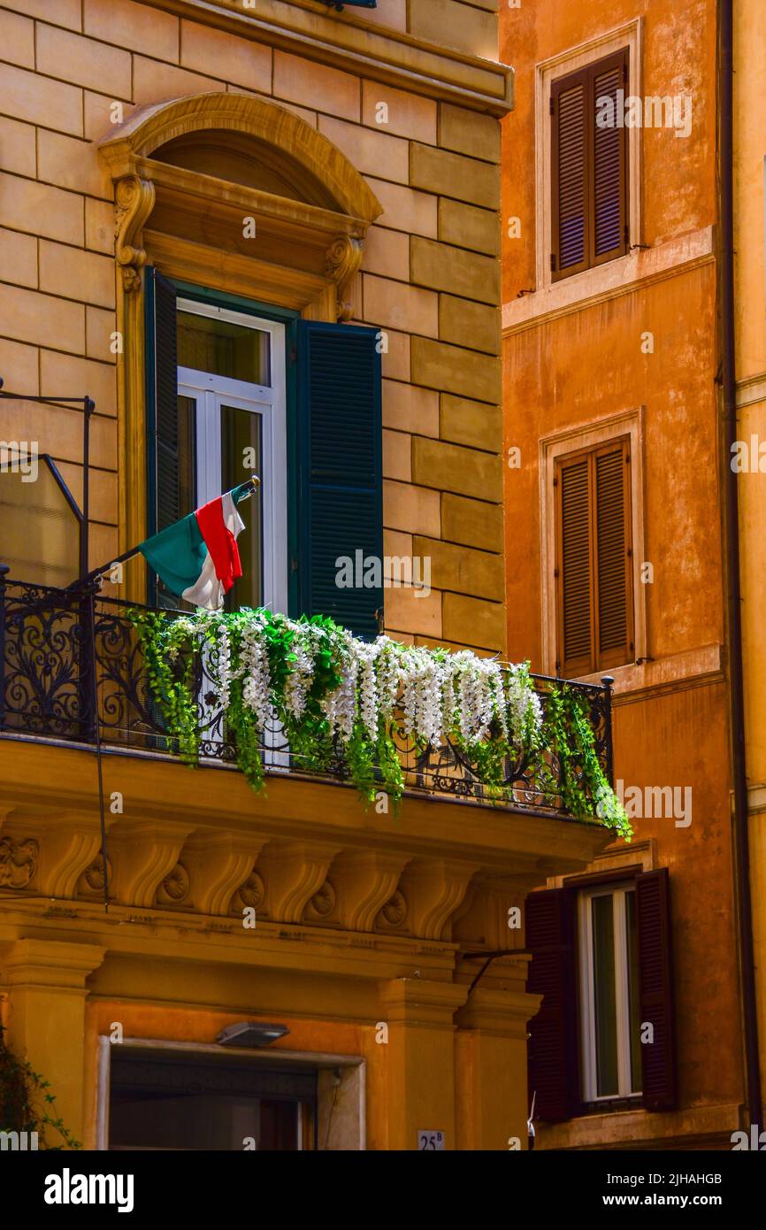 A vertical shot of a classic residential building with Italian flag on ...