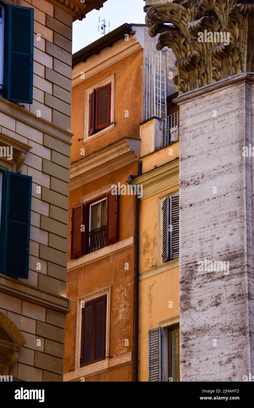 A vertical shot of classic Italian residential buildings with weathered ...
