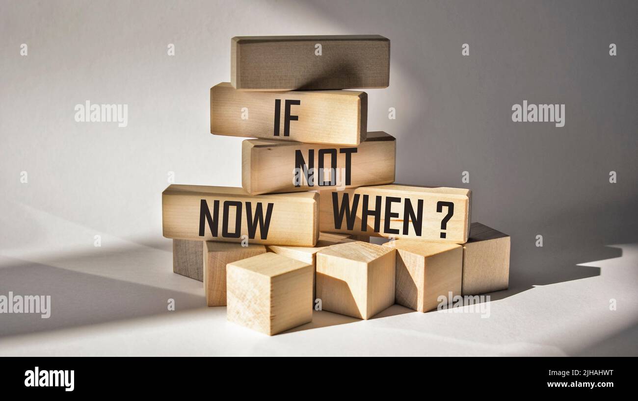 If not now then when symbol on wooden blocks and white background. Copy ...