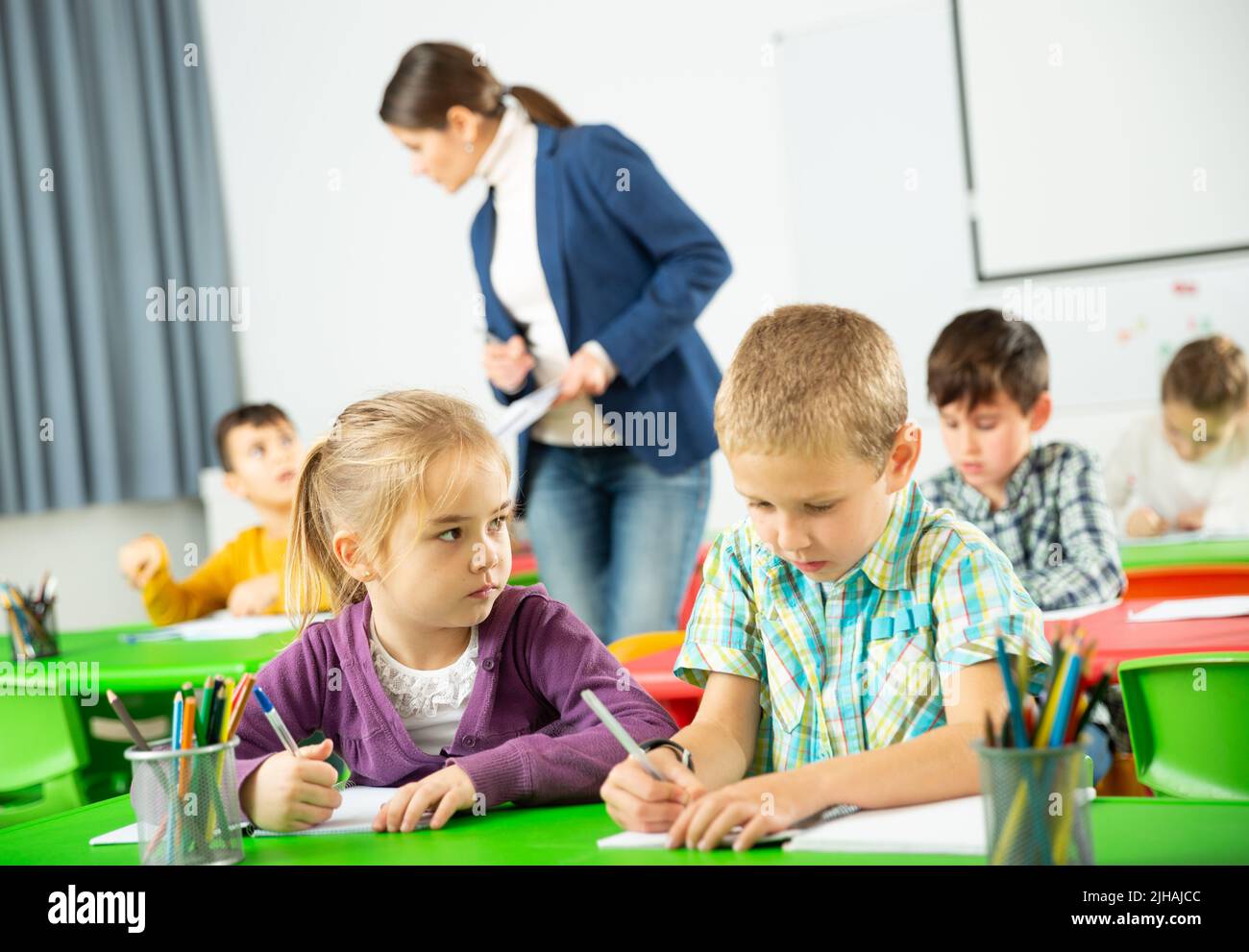 Assiduous kids studying in classroom Stock Photo - Alamy